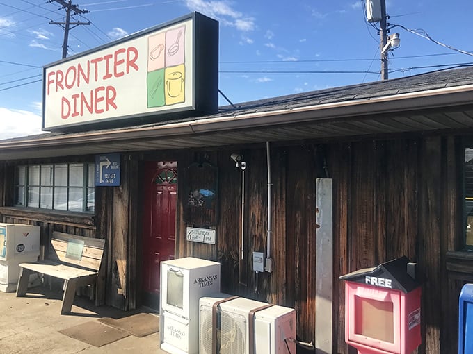 The unassuming wooden exterior of Frontier Diner stands as a time capsule on Asher Avenue, promising comfort food treasures behind that iconic red door.