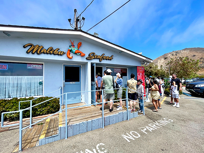 The iconic blue-and-white facade of Malibu Seafood stands like a beacon for hungry beach-goers, complete with that charming lobster logo promising oceanic delights within.
