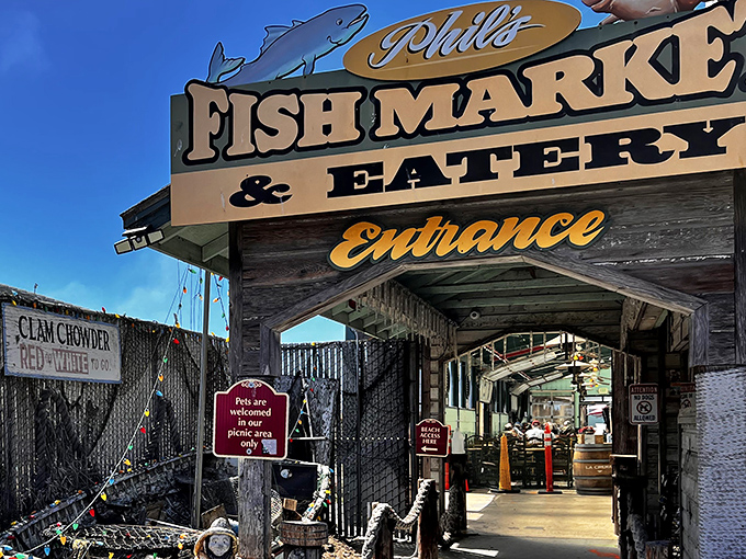 The entrance to seafood paradise! Phil's Fish Market & Eatery welcomes hungry pilgrims with its weathered wooden charm and promise of oceanic delights.