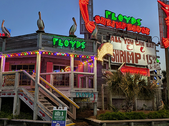 Floyd's neon sign blazes against the twilight sky, a beacon for seafood lovers with promises of "ALL YOU CAN EAT SHRIMP."