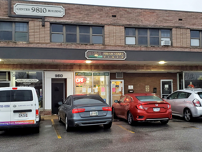 The unassuming storefront of Fresh Start Diner beckons with its cheerful sun logo and promise of morning salvation for the hungry traveler.