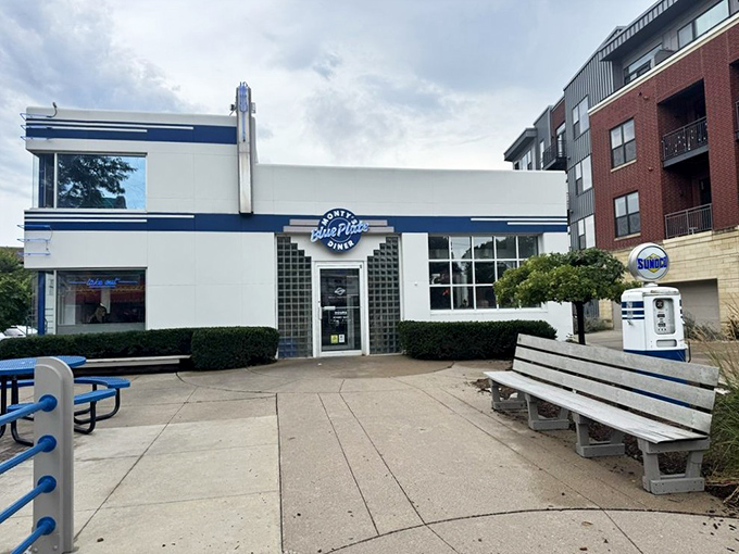 The gleaming white and blue exterior of Monty's Blue Plate Diner stands as a retro beacon on Atwood Avenue, promising nostalgic comfort with a progressive twist.