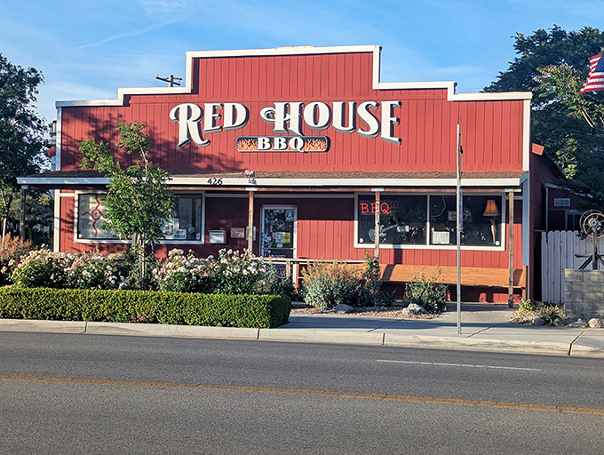 The crimson facade of Red House BBQ stands proudly against the Tehachapi sky, like a beacon calling hungry travelers home to barbecue paradise.