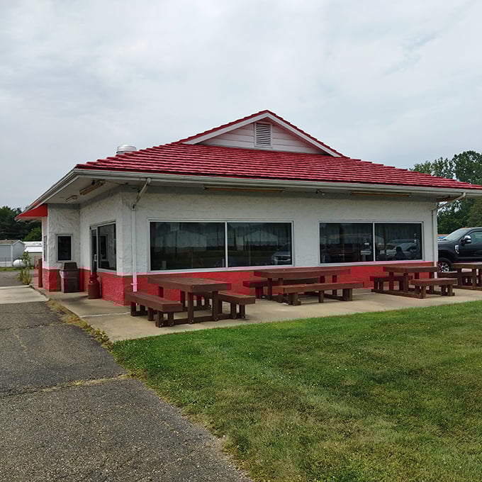 The iconic red-roofed sanctuary of smoke and flavor stands unassumingly along the roadside, promising barbecue salvation to those wise enough to stop.