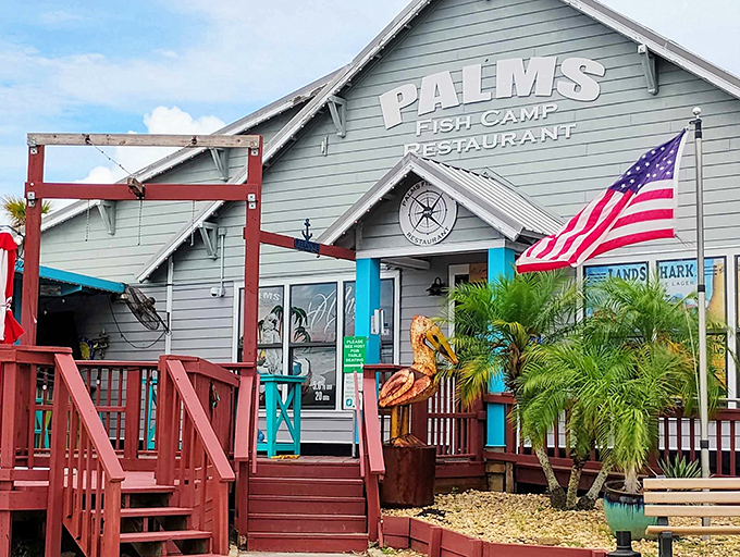 Old Florida charm greets you at the entrance, where weathered wood, palm trees, and a giant decorative crab set the stage for seafood bliss.