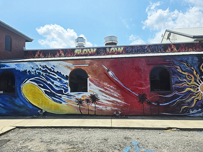 The vibrant mural wrapping Slow & Low's exterior isn't just decoration&mdash;it's a promise of the flavor explosion waiting inside. Beach meets barbecue in perfect harmony.