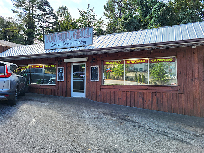 Blue metal roof, rustic wooden siding, and a straightforward sign – the universal code for "prepare your taste buds for something memorable" in small-town America.