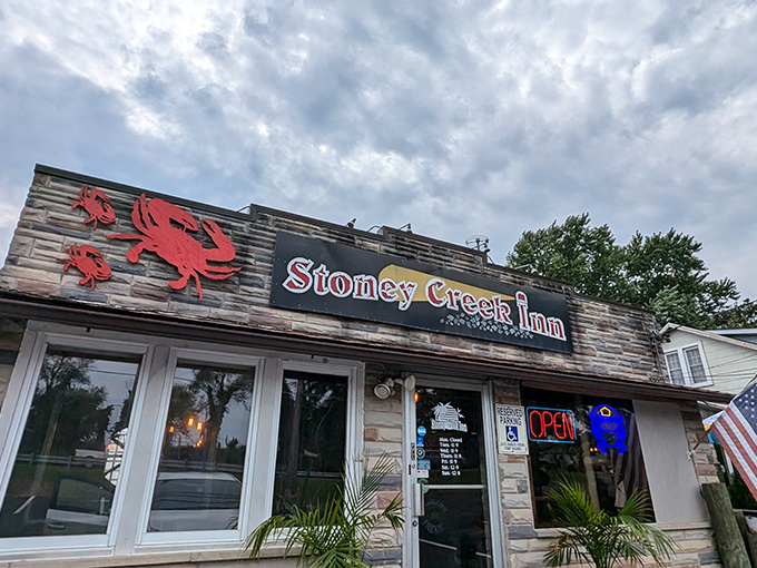 Dramatic skies frame Stoney Creek Inn's fa&ccedil;ade, where those red crab emblems aren't just decoration&mdash;they're a delicious promise of what awaits inside.