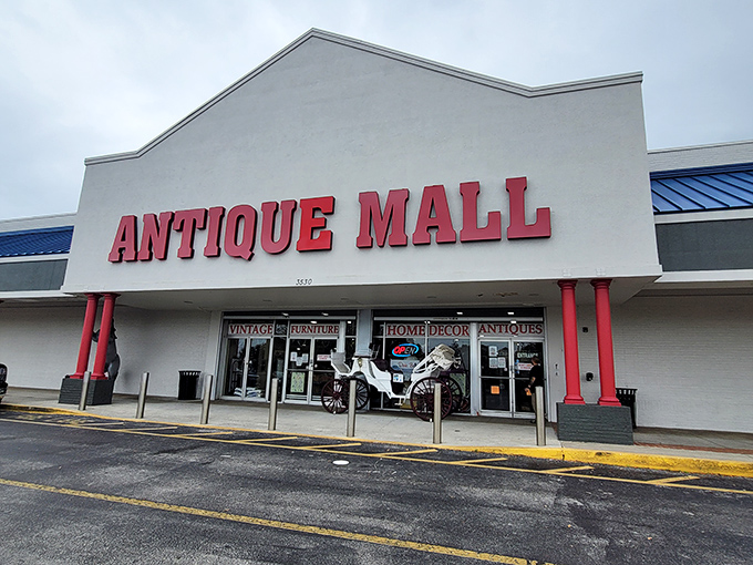 The unassuming exterior of Lakeland Antique Mall, with its bold red signage and columns, gives little hint of the treasure trove waiting inside.