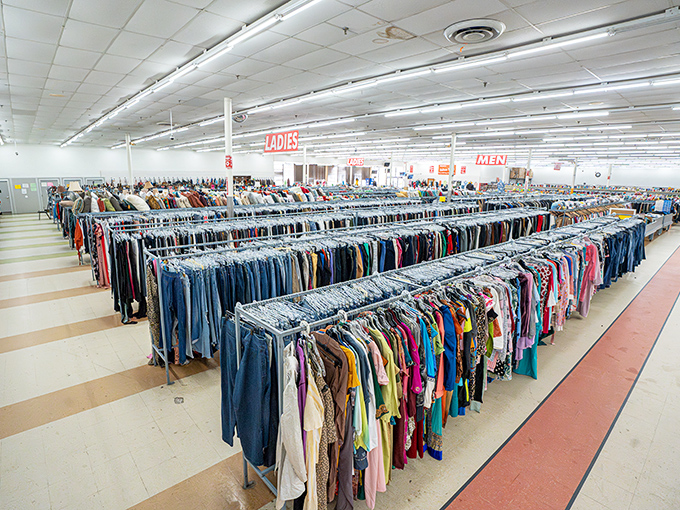 Rows upon rows of fashion possibilities stretch toward the horizon like a secondhand sea. The "Ladies" and "Men" signs serve as navigational beacons in this treasure-hunting paradise.