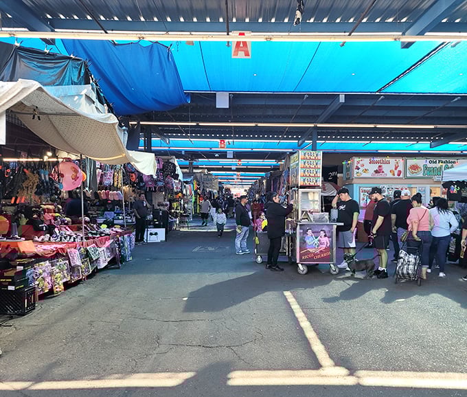 Blue tarps create a desert oasis of commerce where treasure hunters navigate aisles of possibility, each turn promising new discoveries.