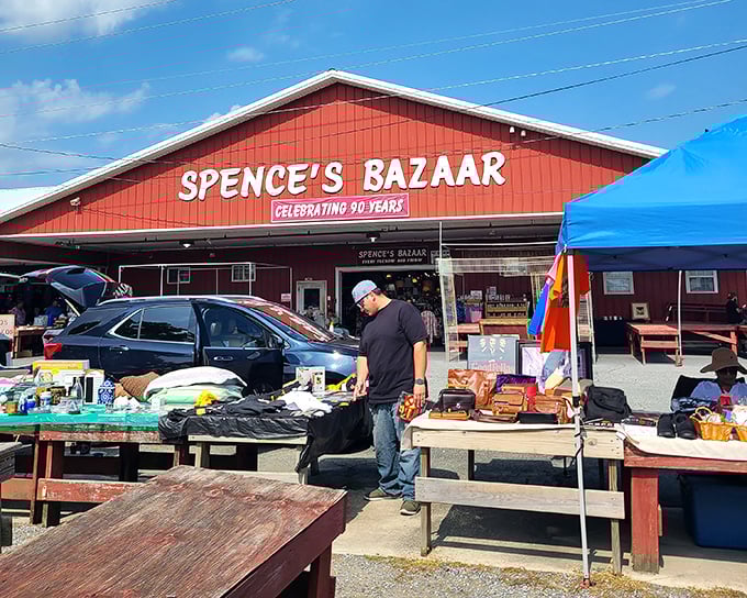 The iconic red barn of Spence's Bazaar stands like a beacon for bargain hunters, promising treasures that big-box stores could never deliver.