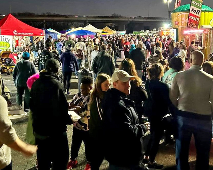 The night comes alive under a canopy of colorful tents, where strangers become friends and every aisle promises a new discovery.