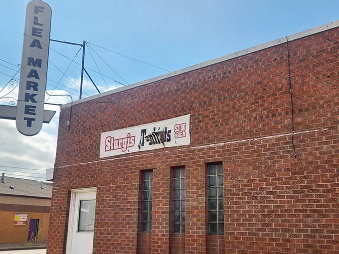 A vintage "FLEA MARKET" sign beckons treasure hunters like a lighthouse for the nostalgically inclined.