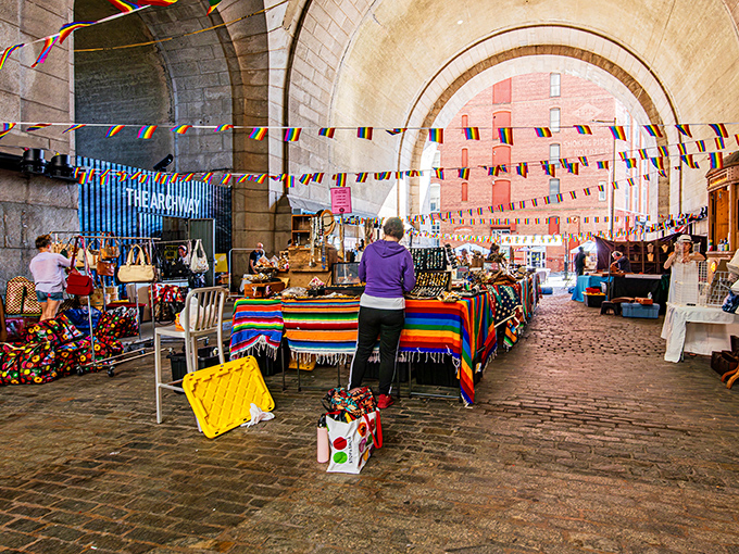 Under DUMBO's historic archway, treasure hunters browse colorful vendor displays where Brooklyn's past meets its creative present.