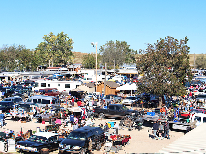 A bird's-eye view reveals the magnificent sprawl of Mary's Swap Meet&mdash;a bustling marketplace where vehicles become impromptu storefronts and deals await discovery.