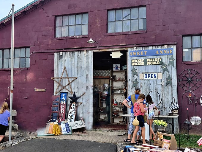 The weathered burgundy building of Sweet Anne's at Rice's Market stands like a time capsule of treasures, beckoning shoppers with its rustic charm and promise of discoveries.