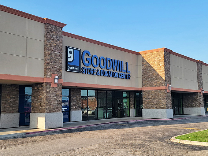 The modern stone-accented facade belies the treasure cave within. That iconic blue Goodwill sign promises adventure for the bargain-minded explorer.