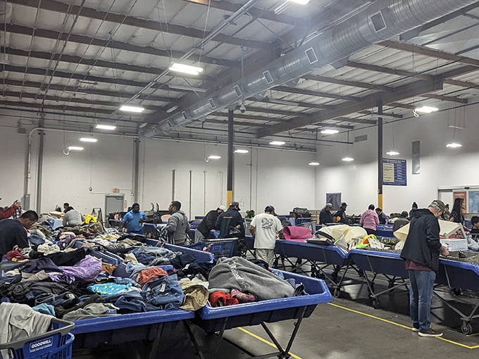 The iconic blue awning of the Goodwill Outlet beckons bargain hunters like a retail lighthouse guiding ships to treasure-filled shores.