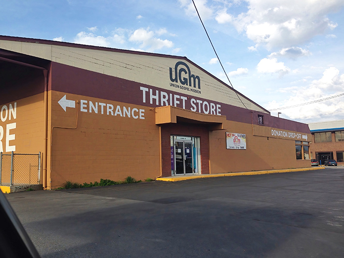 The unassuming exterior of UGM Thrift Store stands like a treasure chest waiting to be opened, its tan walls holding secrets only bargain hunters know.