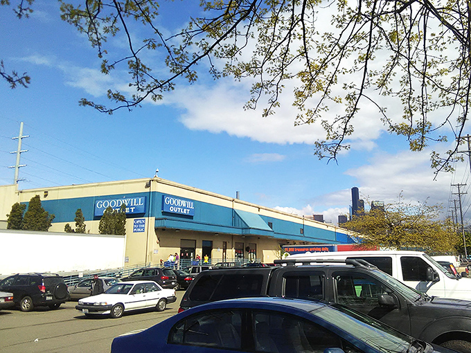 The blue-trimmed exterior of Seattle's Goodwill Outlet beckons like a siren call to thrift enthusiasts and bargain hunters across Washington.