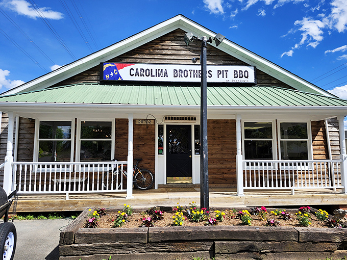 The rustic wooden exterior with its welcoming porch practically whispers, "Slow down, friend. The barbecue inside is worth savoring."