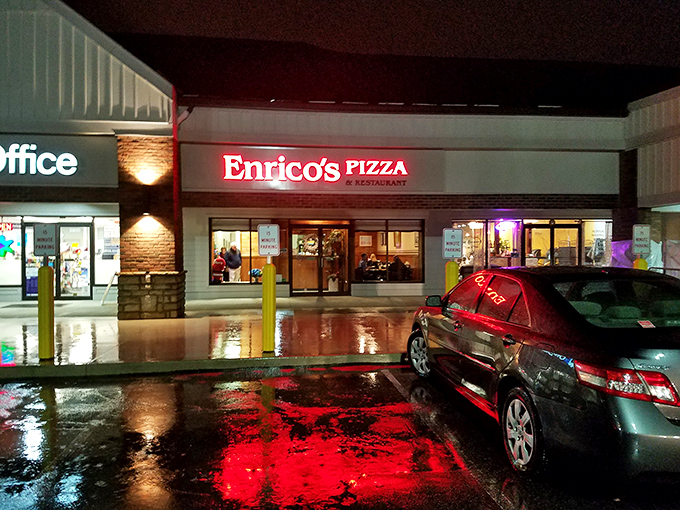 Even at night, Enrico's glowing sign serves as a beacon for pizza pilgrims, its red neon reflecting in puddles like a culinary lighthouse.