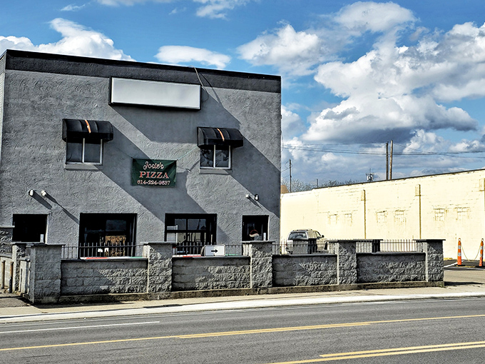 The unassuming gray exterior of Josie's Pizza stands like a culinary fortress on West Broad Street, promising treasures that far exceed its modest appearance.