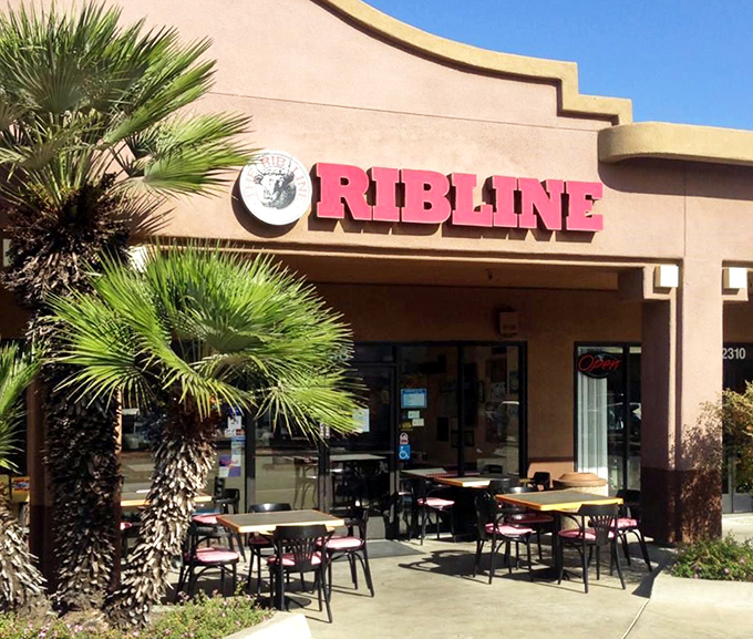 The unassuming storefront of Rib Line beckons with its bold red signage and palm trees. BBQ paradise doesn't always need fancy digs to deliver extraordinary flavor.