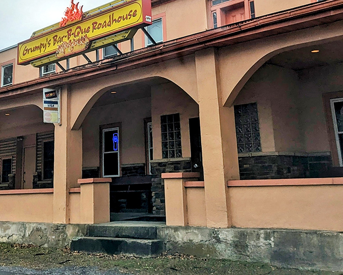 The unassuming exterior of Grumpy's hides barbecue greatness within, like finding a Picasso at a yard sale. That flame-adorned sign is your beacon to smoked meat paradise.