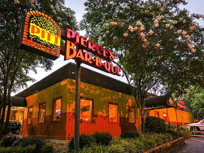 As evening falls, Pierce's neon sign glows like a barbecue beacon, promising that some of Virginia's finest pulled pork awaits just beyond those doors.