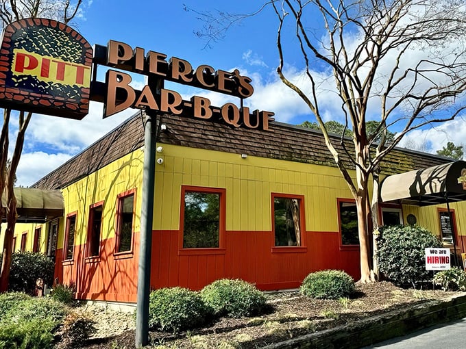 That unmistakable yellow and orange exterior stands like a barbecue beacon, promising smoky delights within Pierce's legendary walls.