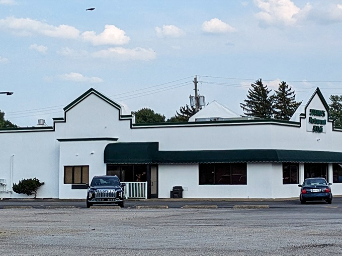 A different angle of Dianna's modest white building with green accents &ndash; where sandwich magic happens daily without the fanfare it deserves.
