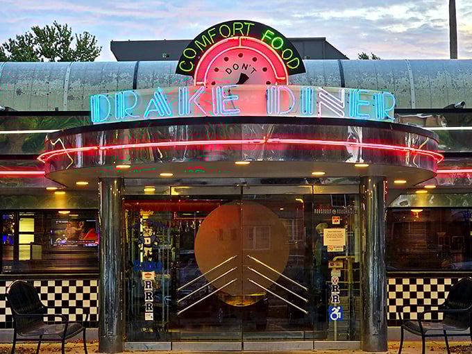 The neon glow of Drake Diner beckons like a lighthouse for the hungry soul. Comfort food never looked so inviting against the twilight sky.