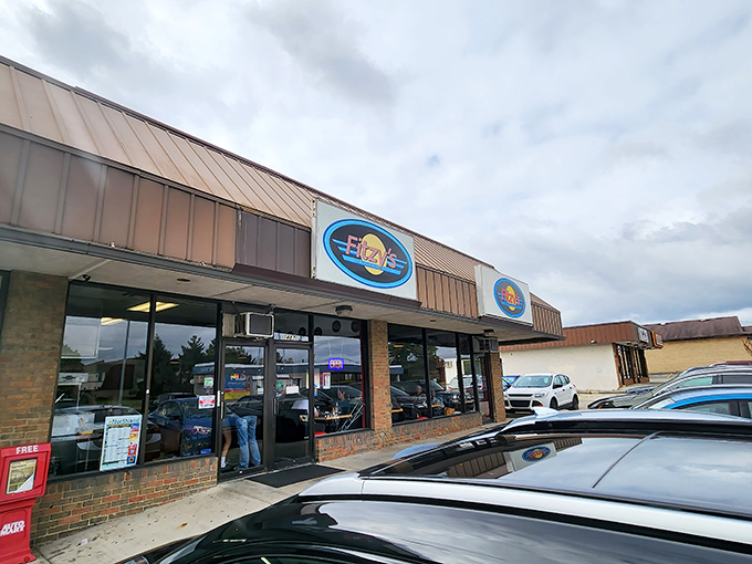 Rain or shine, those iconic blue Fitzy's signs beckon hungry travelers with the silent promise of comfort food that transcends weather forecasts.