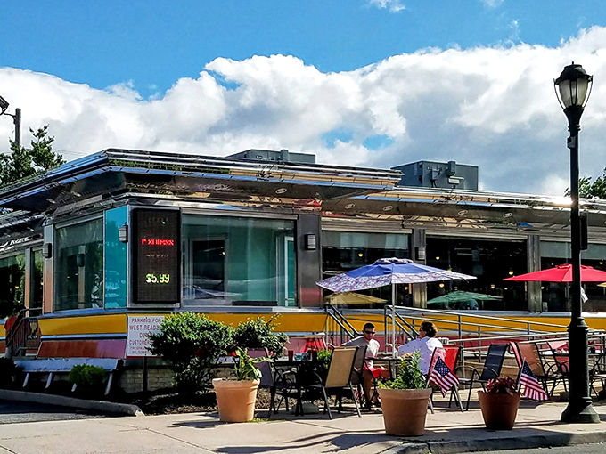 Sunshine bathes the diner's classic exterior while outdoor seating beckons. Like finding an oasis in the desert, but the treasure here is breakfast served all day.