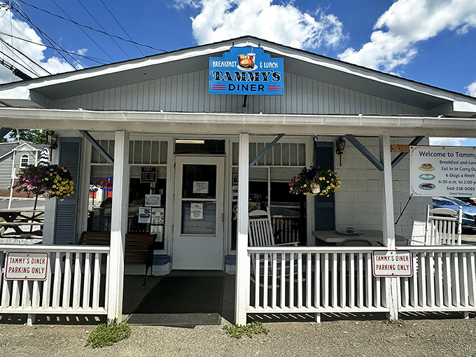 Hanging flower baskets frame the entrance like nature's welcome committee, inviting hungry travelers into this Round Hill treasure.