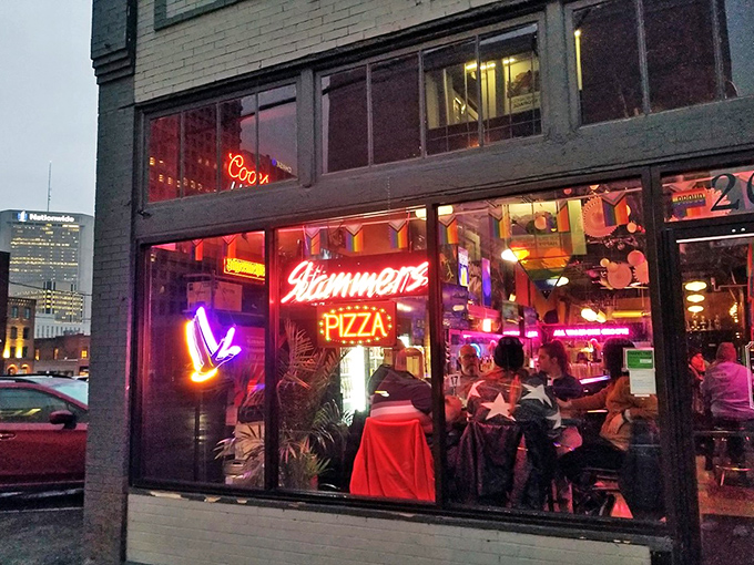 The neon glow of Slammers beckons like a lighthouse for the pizza-starved, promising delicious refuge in downtown Columbus after dark.