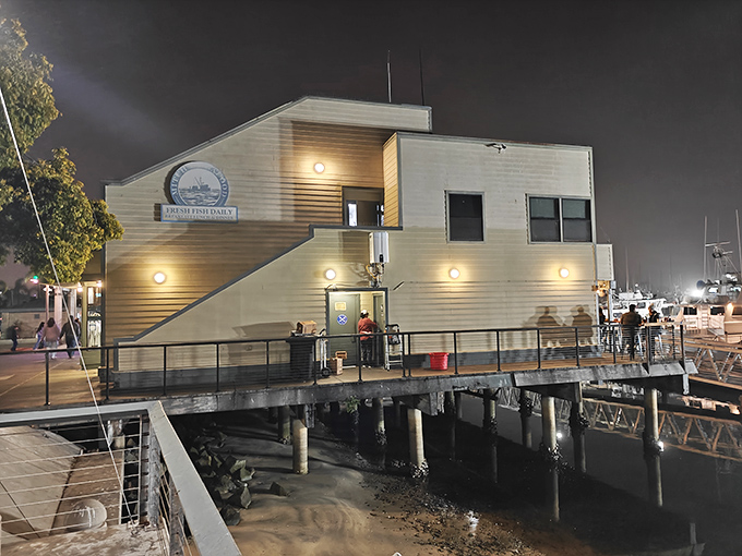Perched on stilts over the water, Mitch's Seafood glows like a beacon for hungry sailors and landlubbers alike as evening settles over Point Loma.
