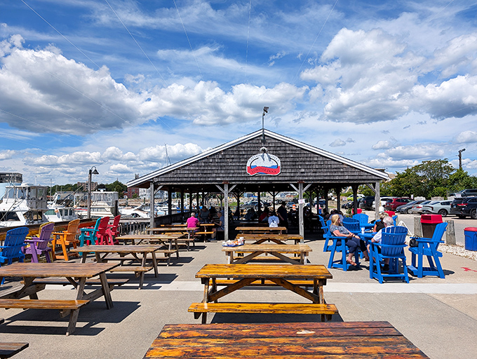 Where picnic tables become thrones and every seat offers front-row tickets to the maritime ballet of bobbing boats.