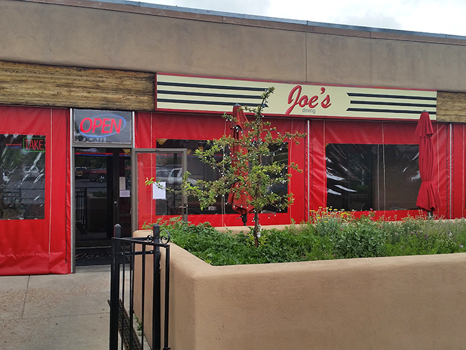 Joe's vibrant red exterior isn't just a building&mdash;it's a beacon of culinary promise standing proudly against the Santa Fe sky.