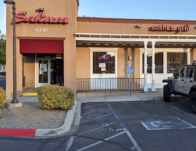 The unassuming exterior of Sakura Sushi & Grill proves once again that culinary treasures often hide in plain sight. That neon "OPEN" sign is practically winking at you.