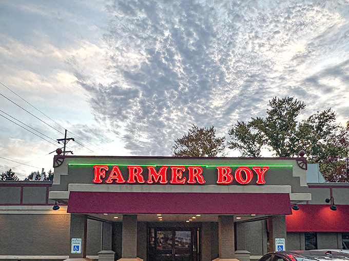 The iconic red Farmer Boy sign glows like a beacon for breakfast lovers, promising morning salvation under an Ohio sky painted with cotton-candy clouds.