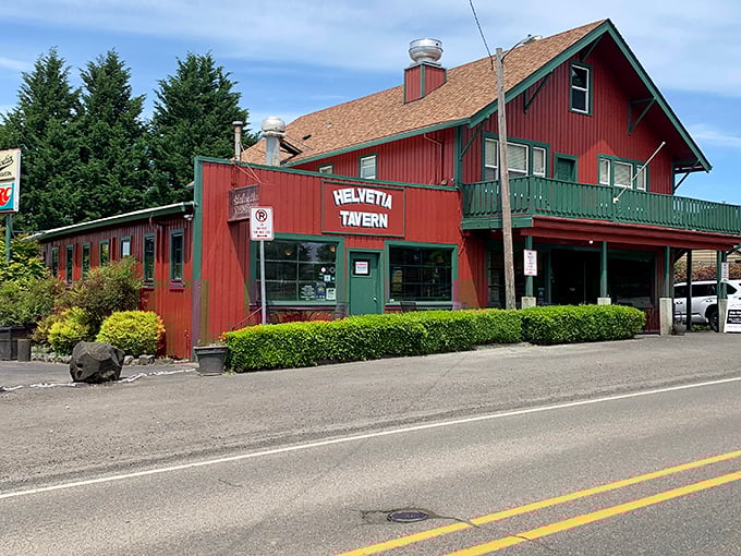 The iconic red exterior of Helvetia Tavern stands like a beacon for burger pilgrims, promising no-frills deliciousness in Oregon's countryside.