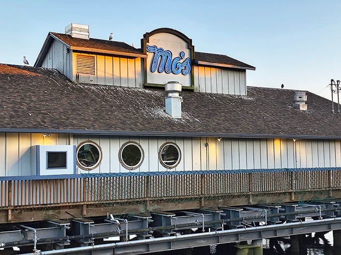 Those nautical porthole windows aren't just for show—they frame perfect little postcards of Oregon coastal life while you devour seafood treasures.