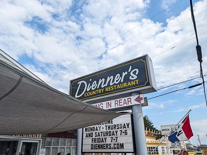Dienner's iconic sign stands against Pennsylvania's blue sky, promising authentic country cooking and directing pie pilgrims to parking in the rear.