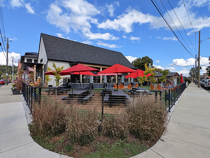 The outdoor dining area at Pinchy's offers a splash of color with vibrant red umbrellas, creating a perfect spot to slurp oysters while soaking up Tennessee sunshine.