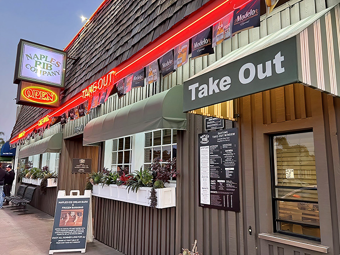 The unassuming exterior of Naples Rib Company hides culinary treasures within, like a wooden-shingled speakeasy for barbecue enthusiasts.