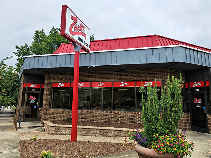 The iconic red-roofed sanctuary beckons hungry travelers like a lighthouse for the famished. No fancy frills, just hot dog perfection waiting inside.
