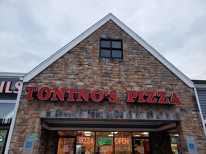Stone facade, bold red lettering, and a simple bench out front&mdash;Tonino's doesn't need fancy frills when the pizza inside speaks volumes.